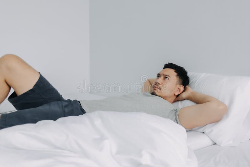 Serious and Depressed Man Overthinking the Problems Lying on the Bed ...