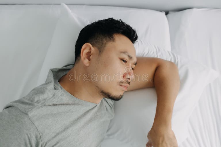 Serious and Depressed Man Overthinking the Problems Lying on the Bed ...