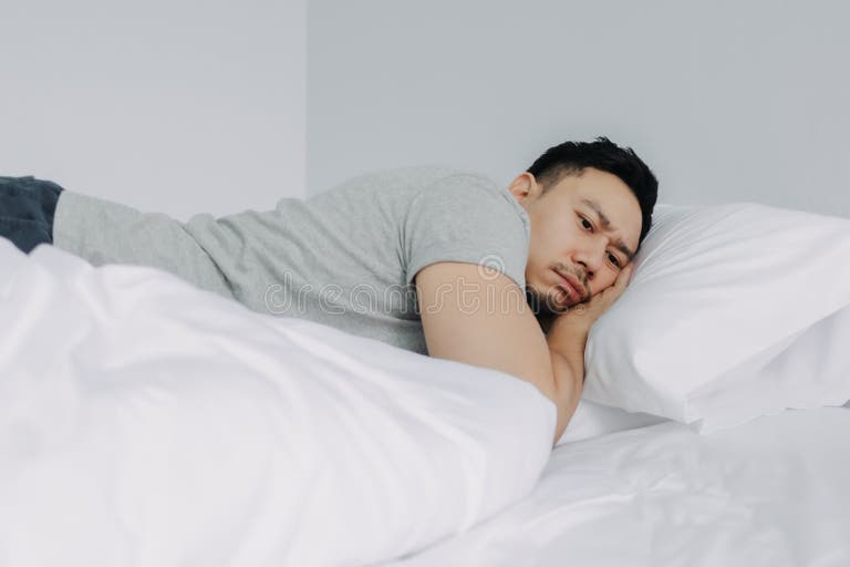 Serious and Depressed Man Overthinking the Problems Lying on the Bed ...