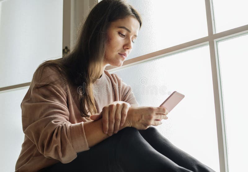 Serious and Distressed Woman Using a Smartphone Stock Image - Image of ...