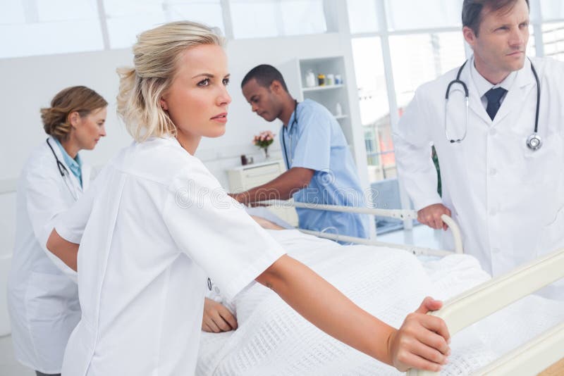 Serious Doctors about To Walk with Patient Bed Stock Photo - Image of ...