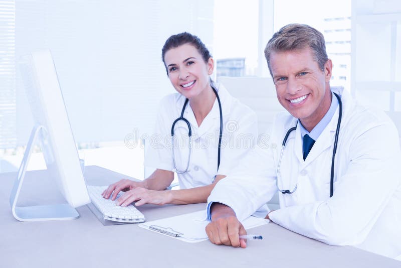 Serious Doctors Using Computer Stock Photo - Image of happy, caucasian ...