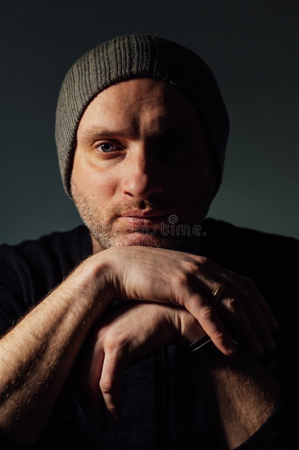Serious Dramatic Man Looking Away while Standing Against Black Studio ...