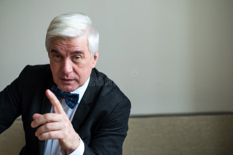 A Serious Elderly Man in a Suit Points His Finger. Stock Photo - Image ...