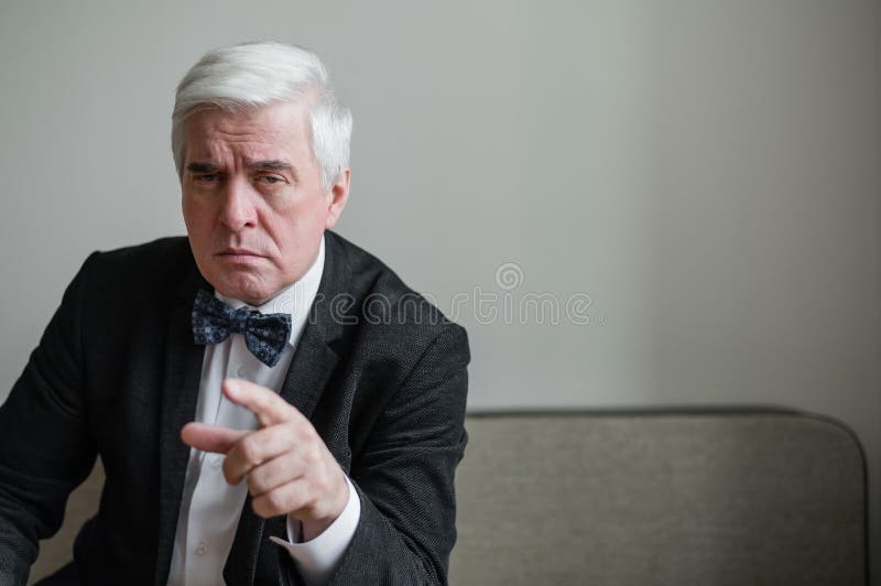 A Serious Elderly Man in a Suit Points His Finger. Stock Image - Image ...