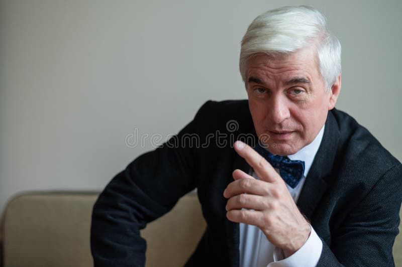 A Serious Elderly Man in a Suit Points His Finger. Stock Image - Image ...