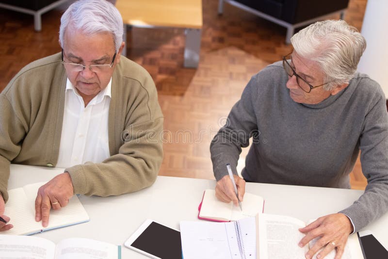 Serious Elderly Men Preparing for Courses in Library Stock Photo ...
