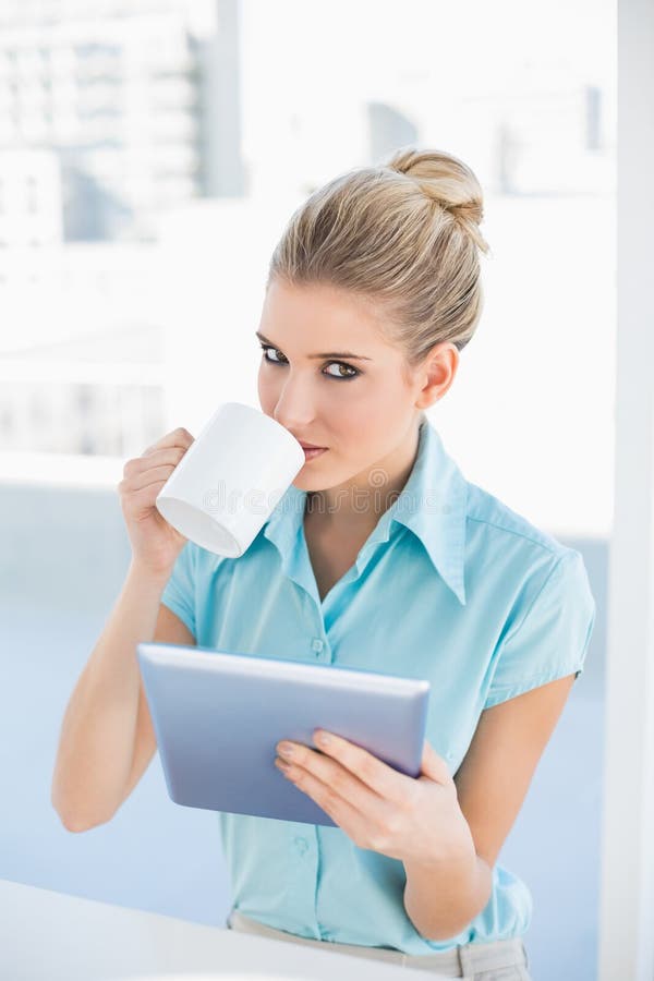 Serious Elegant Woman Using Tablet while Drinking Coffee Stock Photo ...