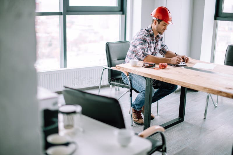 Serious Engineer is Concentrated on Paperwork at Workplace Stock Image ...