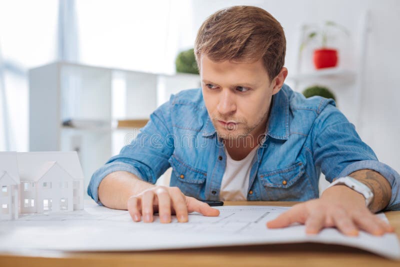 Serious Engineer Putting His Hands on a Scheme while Thinking Stock ...