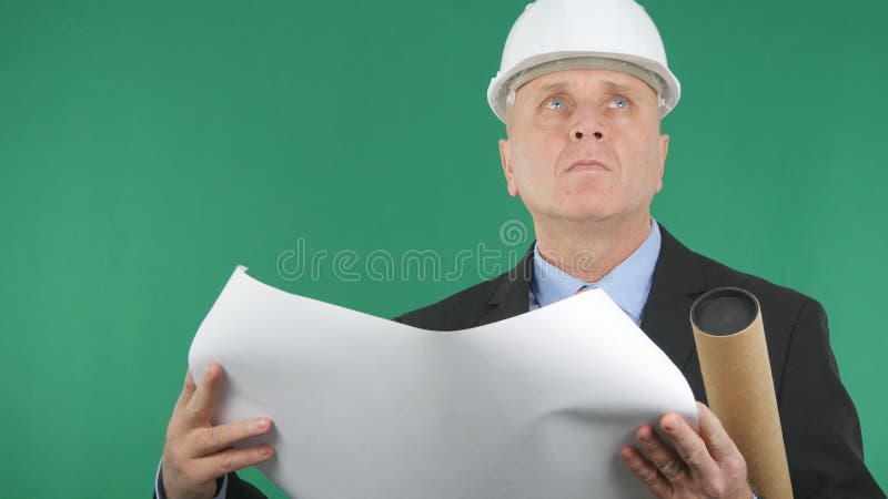 Serious Engineer Reading a Construction Plan with Green Screen in ...