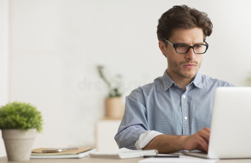 Concentrated Millennial Guy Working on Laptop at Work Stock Image ...