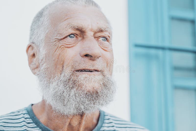 Serious Expression of Man with Blue Eyes. 75 Year Old Senior Man with ...