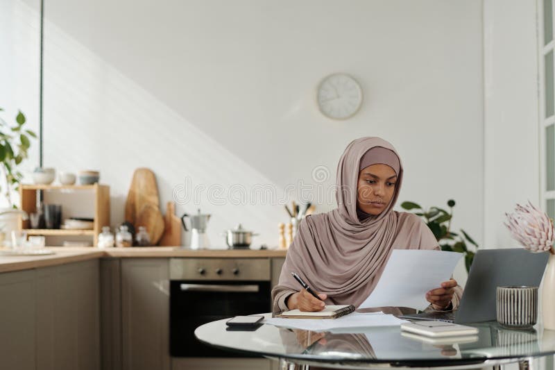 Serious Female Auditor with Business Document Looking through Its Main ...