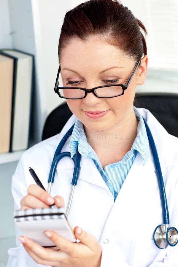 Serious Female Doctor Holding a Notepad Stock Photo - Image of office ...