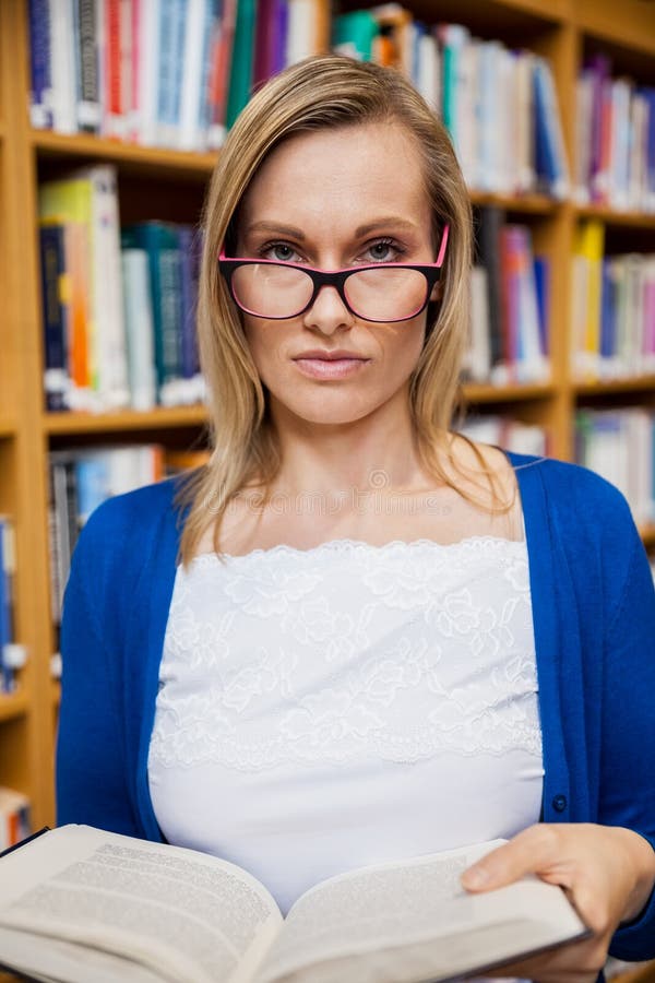 Serious Female Student Reading a Book in the Library Stock Image ...