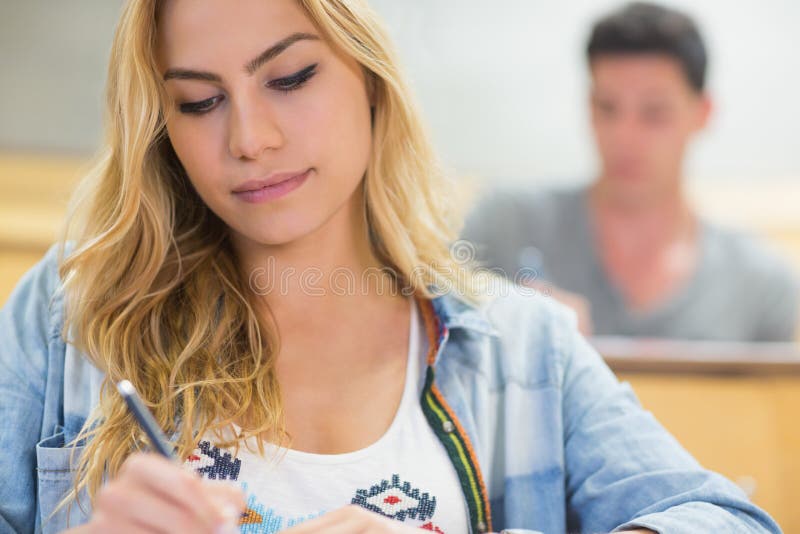 Serious Female Student Writing during Class Stock Image - Image of ...