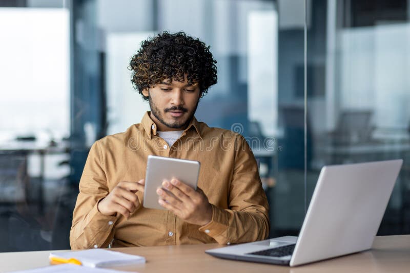 Serious Focused Businessman Working with Tablet Computer Sitting at ...