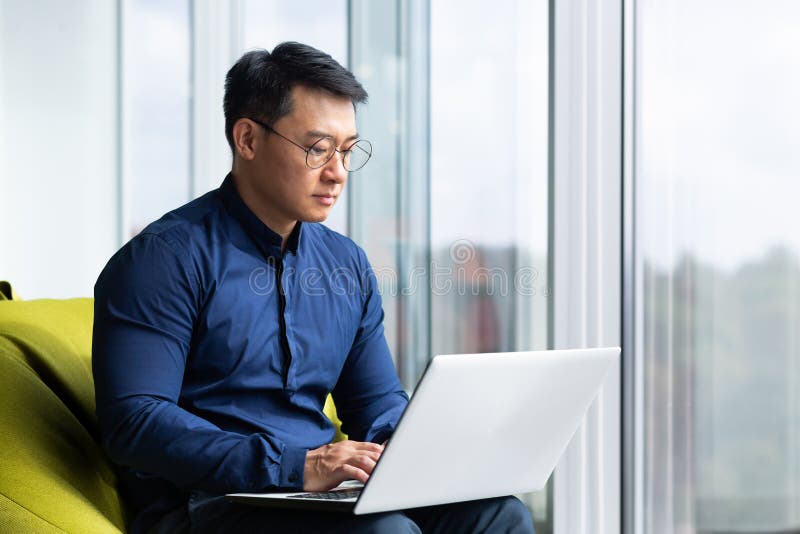 Serious and Focused Engineer Developer Programmer Writing Code Using ...