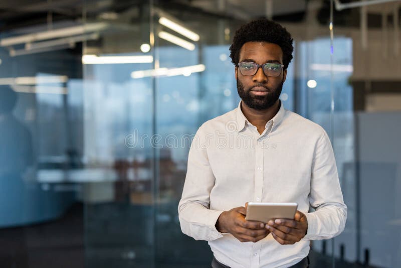 Serious Focused Man Looking at Camera. Businessman with Tablet Computer ...