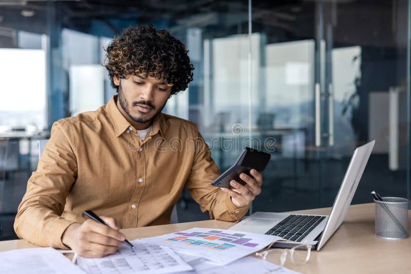 Serious and Focused Young Indian Man Working in Office at Desk with ...