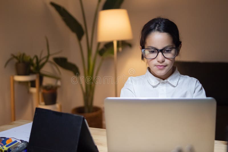 Serious Girl Geek in Glasses Programming Using Laptop and Tablet Stock ...