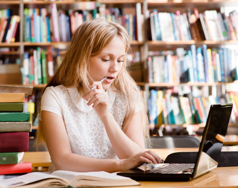 Serious Girl Typing on Notebook in Library Stock Image - Image of ...