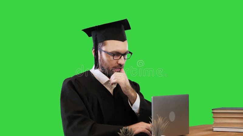 Serious Grad Student Using a Laptop on a Green Screen, Chroma Key ...