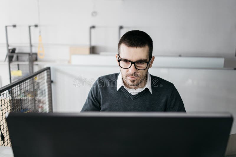Serious Guy Looking into a Computer Desktop Stock Photo - Image of ...