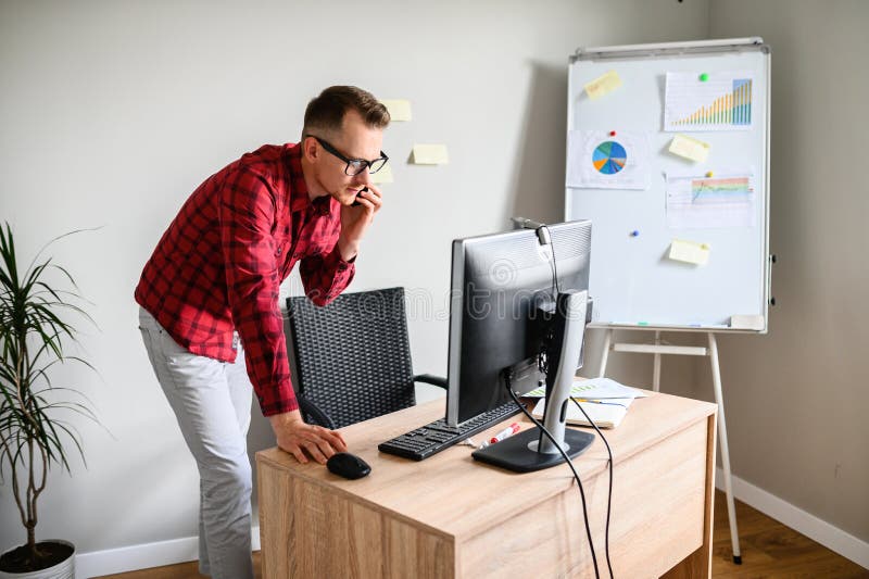 Serious Guy Stands in Office Talking on Phone Stock Photo - Image of ...