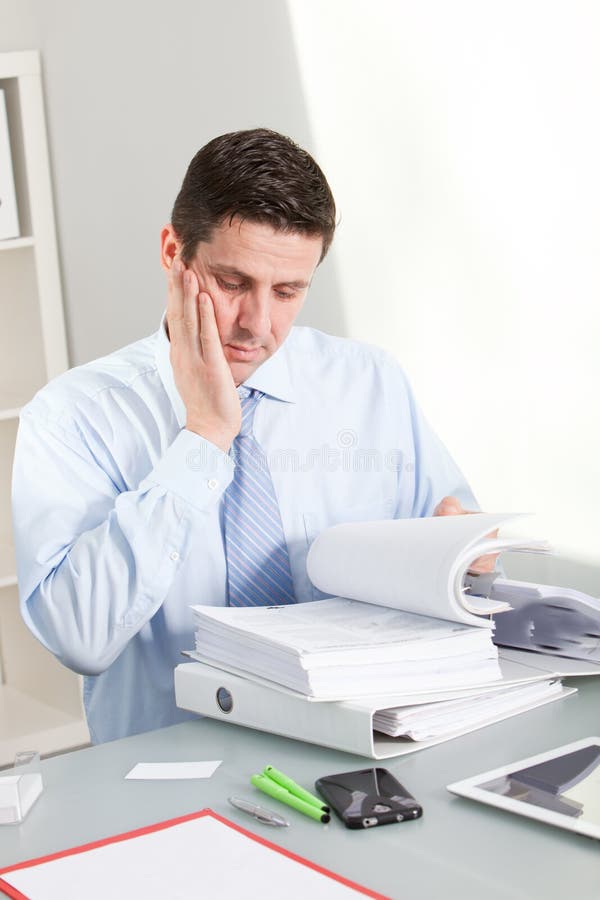 Serious Handsome Employee Reading Manuals Stock Image - Image of ...