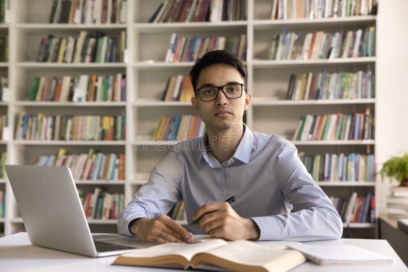 Serious Indian Male Student Studying in Library Stock Image - Image of ...