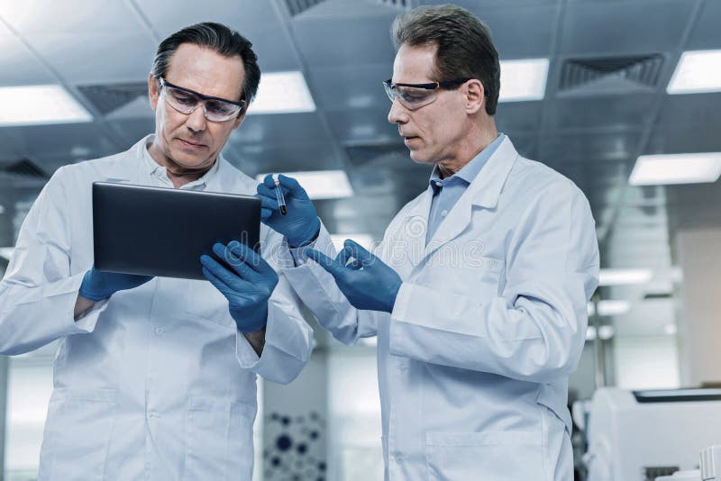 Serious Intelligent Man Holding a Tablet Stock Photo - Image of ...