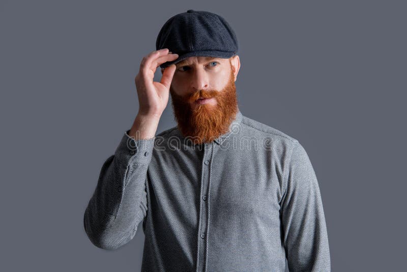 Serious Irish Man Adjusting Cap Studio. Portrait of Bearded Man Stock ...