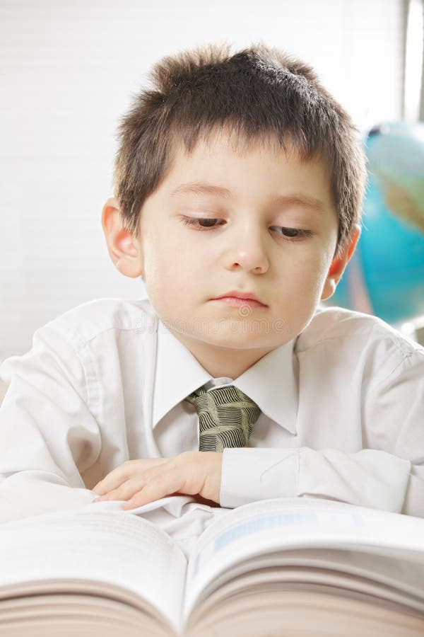 Serious kid reading book stock image. Image of formal - 26461715
