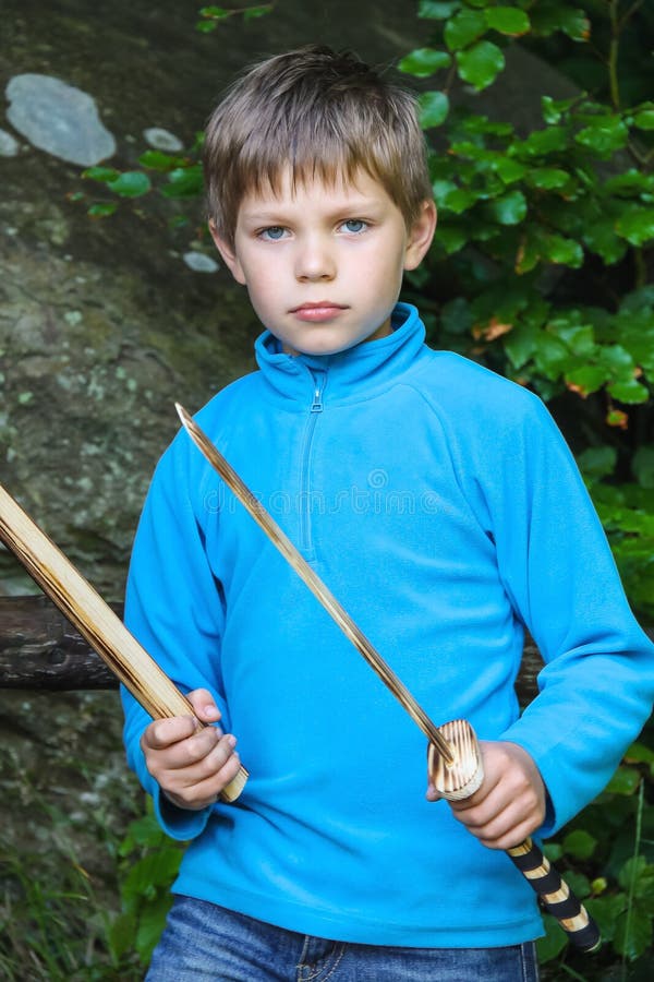 Serious Kid with a Wooden Sword on Stone Stock Image - Image of playful ...