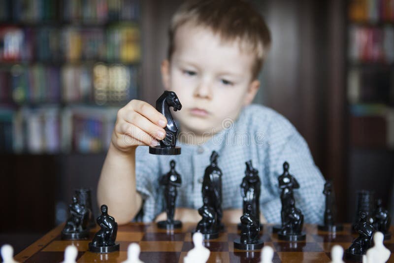 Little boy playing chess. stock image. Image of happy - 185797231