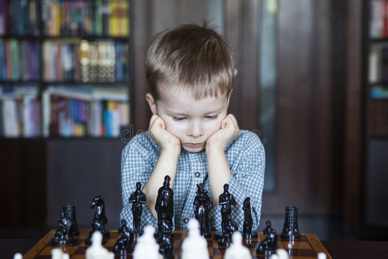 Little boy playing chess. stock image. Image of board - 185797373