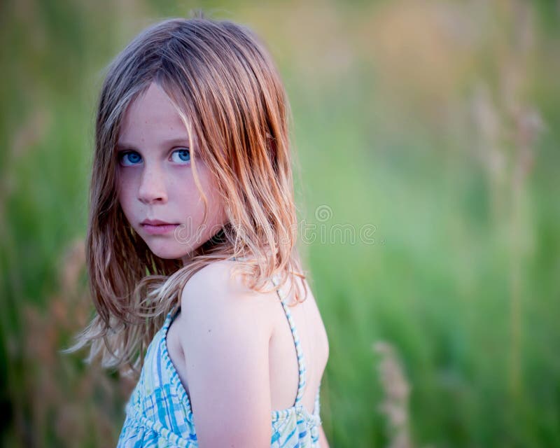 Serious Little Girl in Field Stock Photo - Image of blonde, grass: 33328092