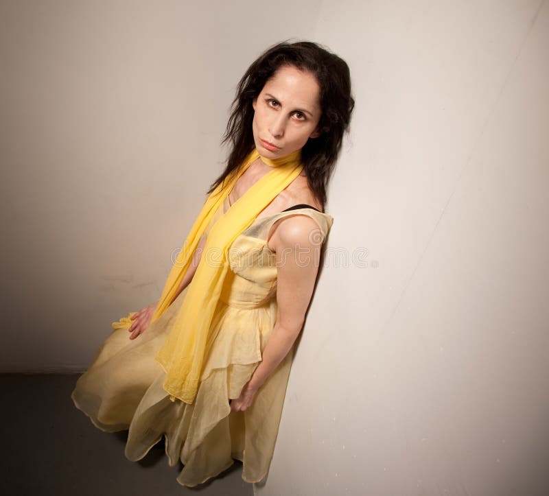 Serious Looking Woman in a Yellow Dress Stock Photo - Image of long ...