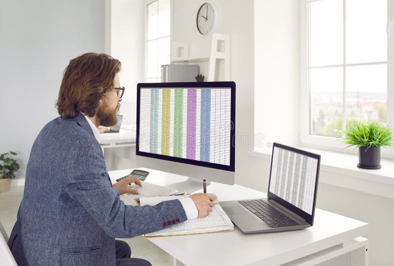 Male Accountant in Office Working Using Accounting Report Spreadsheet ...