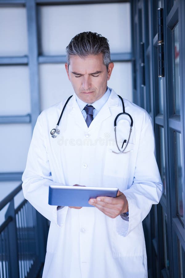 Serious Male Doctor Using Digital Tablet Stock Photo - Image of person ...