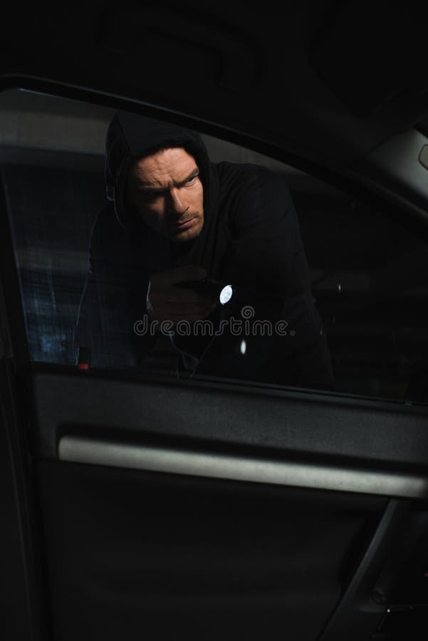Serious Male Robber in Black Hoodie with Flashlight Looking Stock Image ...