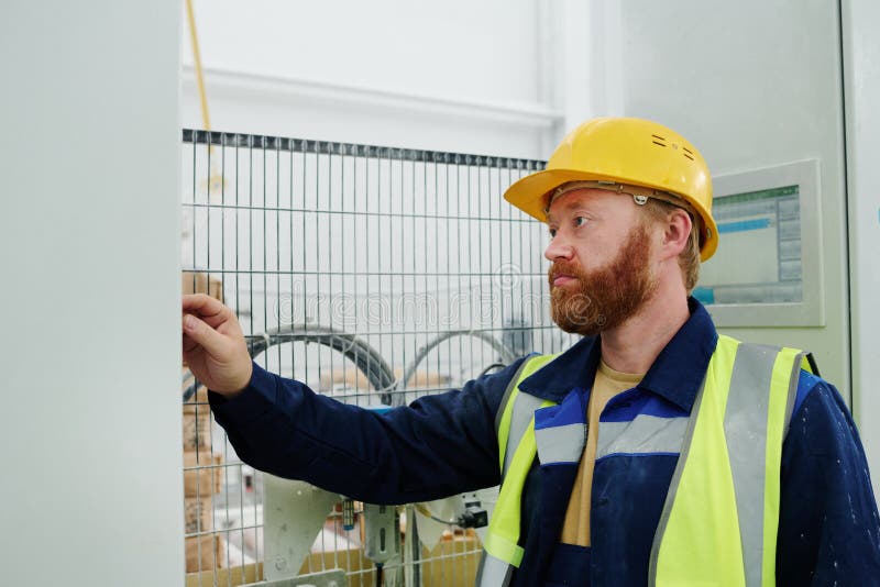 Serious Male Technician or Engineer Pressing Start Button To Switch on ...