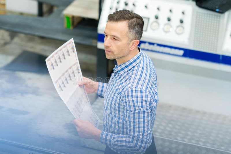 Serious Male Worker Holding Documents Stock Image - Image of indoor ...