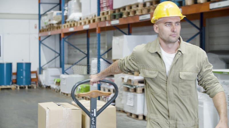 Serious Male Worker Pulling Trolley with Cardboard Boxes. Stock Footage ...