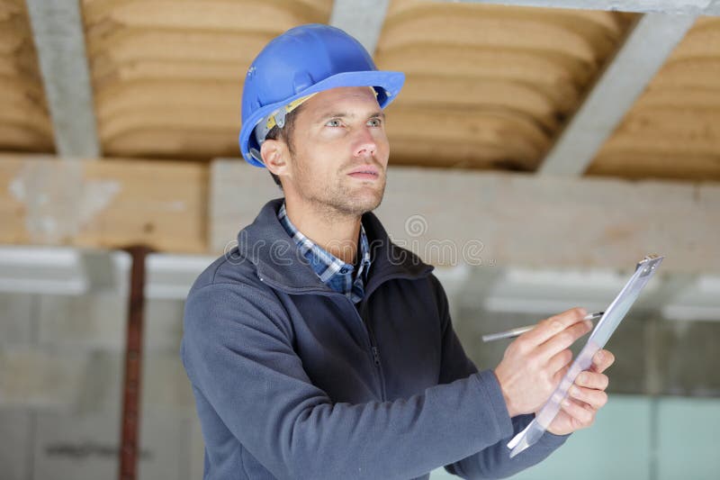 Serious Man Builder in Hard Hat Writing on Clipboard Stock Image ...