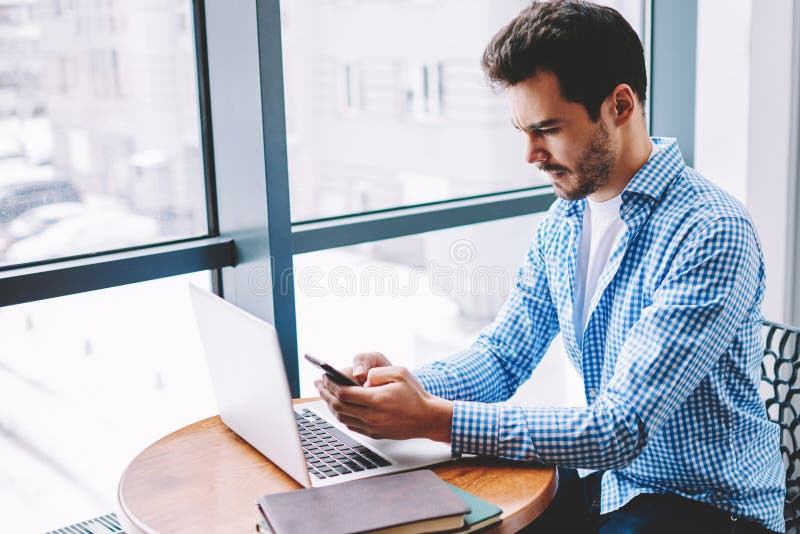 Concentrated Male Freelancer Sharing Information Via Smartphone and ...