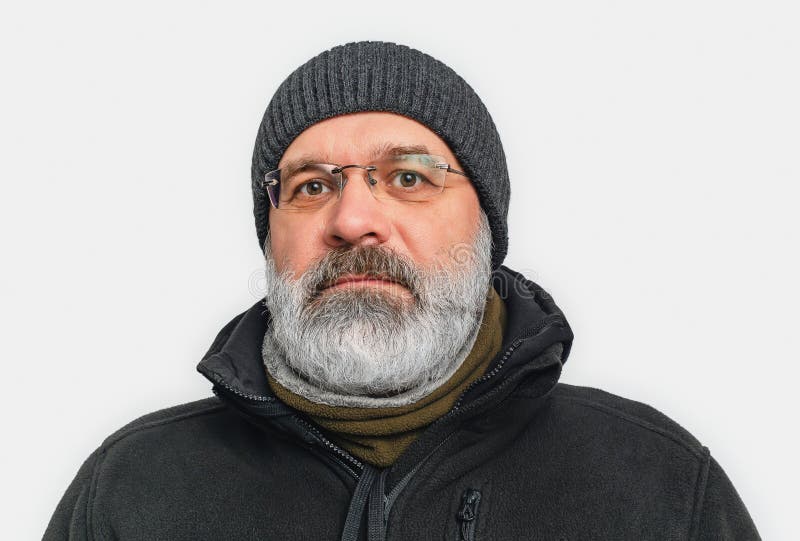 Serious Man with Gray Beard and Mustache in Winter Hat. Looks into ...