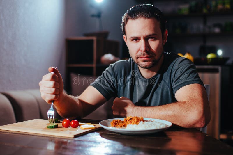 Serious man having dinner stock image. Image of front - 364476191